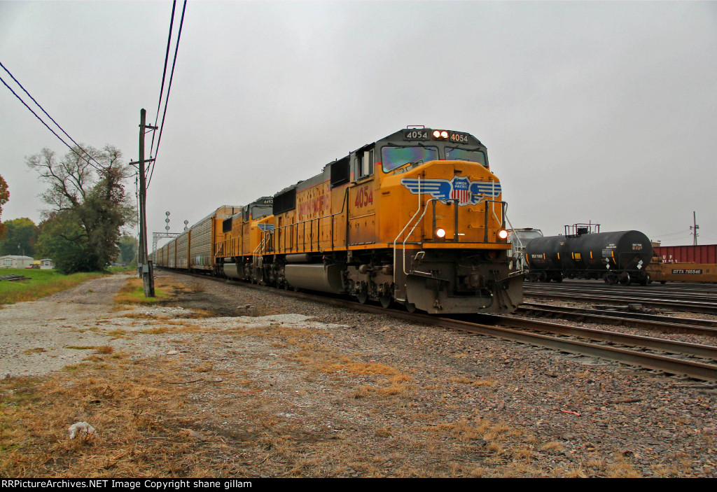 UP 4054 heads up a Nb rack train into dupo.